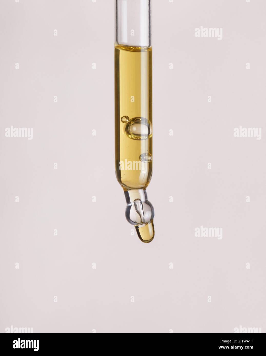 Top view of glass pipette with yellow Hyaluronic acid for skin care on ...