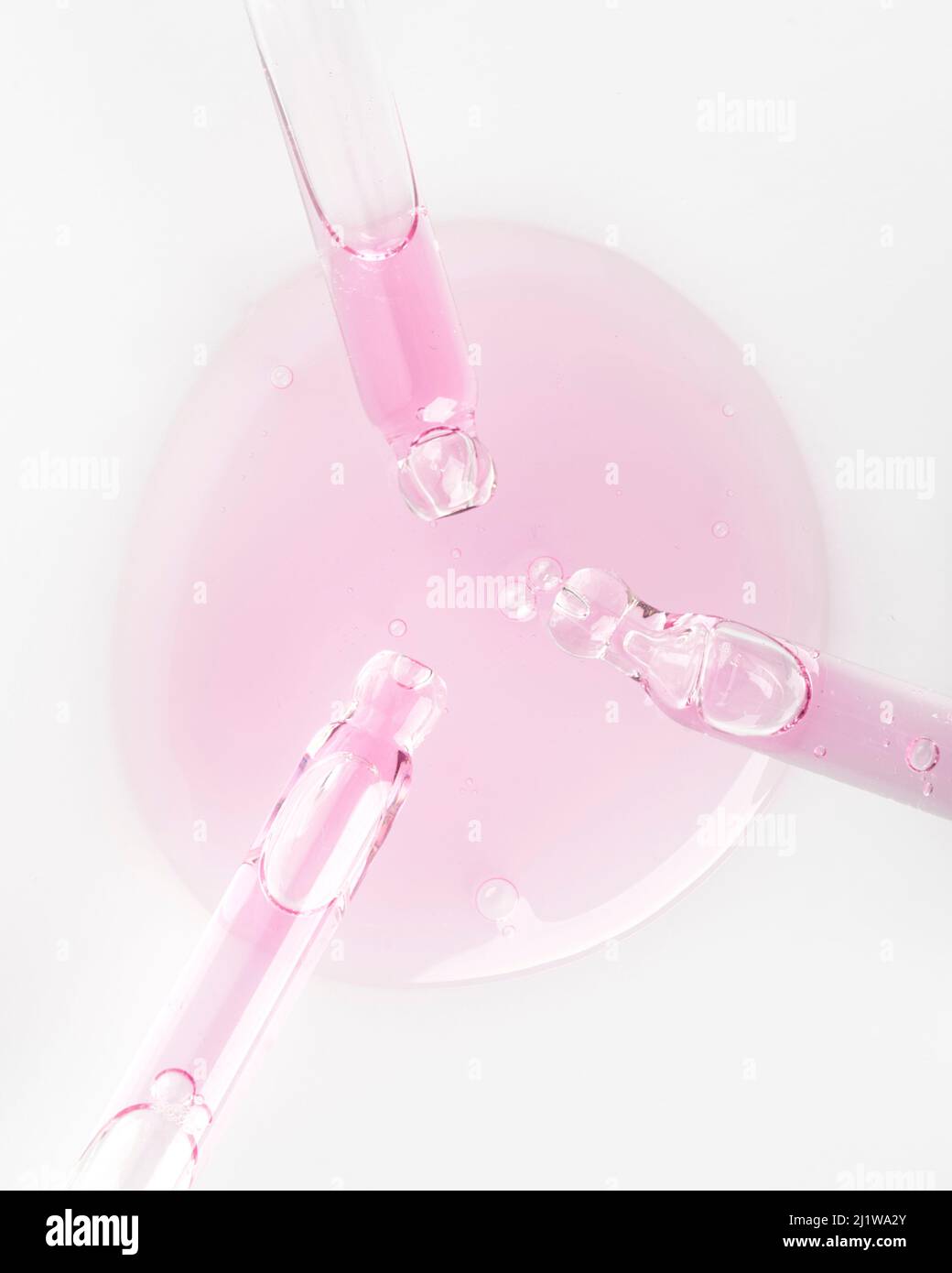 Top view of glass pipettes with natural pink Hyaluronic acid for skin ...