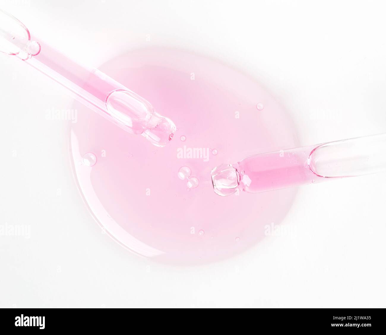 Top view of glass pipettes with natural pink Hyaluronic acid for skin ...