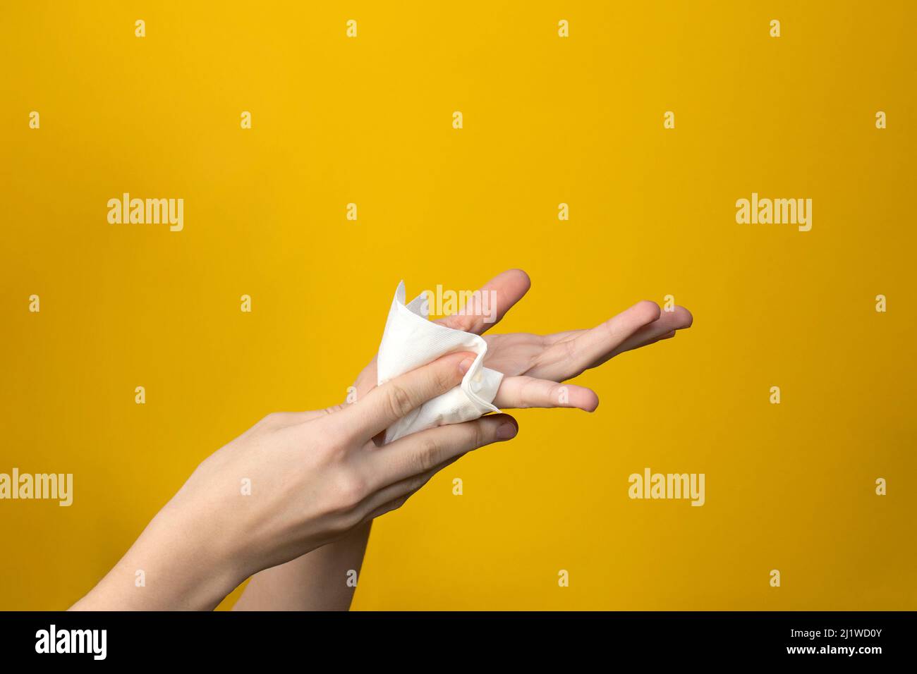 Female cleaning hands using antiseptic wet wipe hi-res stock ...