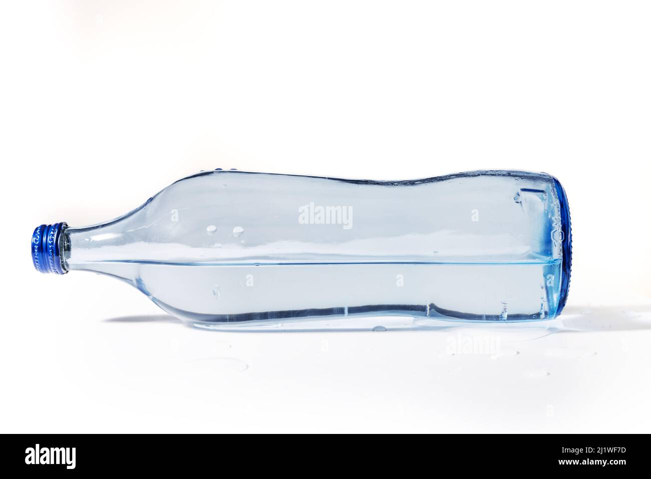 Glass water bottle lying down and isolated on white background Stock ... Glass water bottle lying down and isolated on white background Stock ...