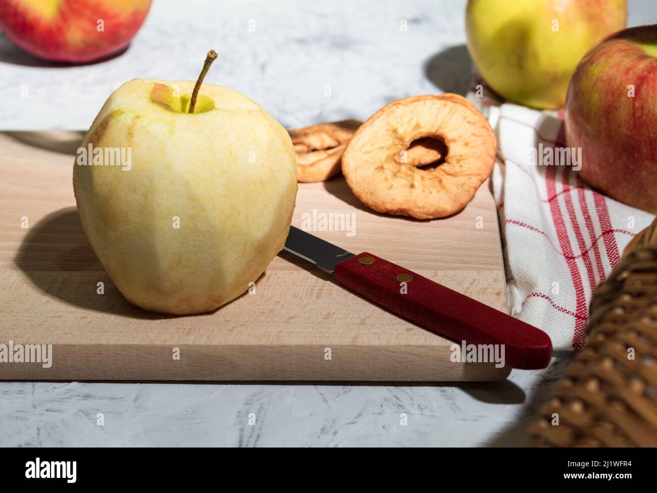 Peeled ripe red apple on a kitchen countertop, side view. Background ...