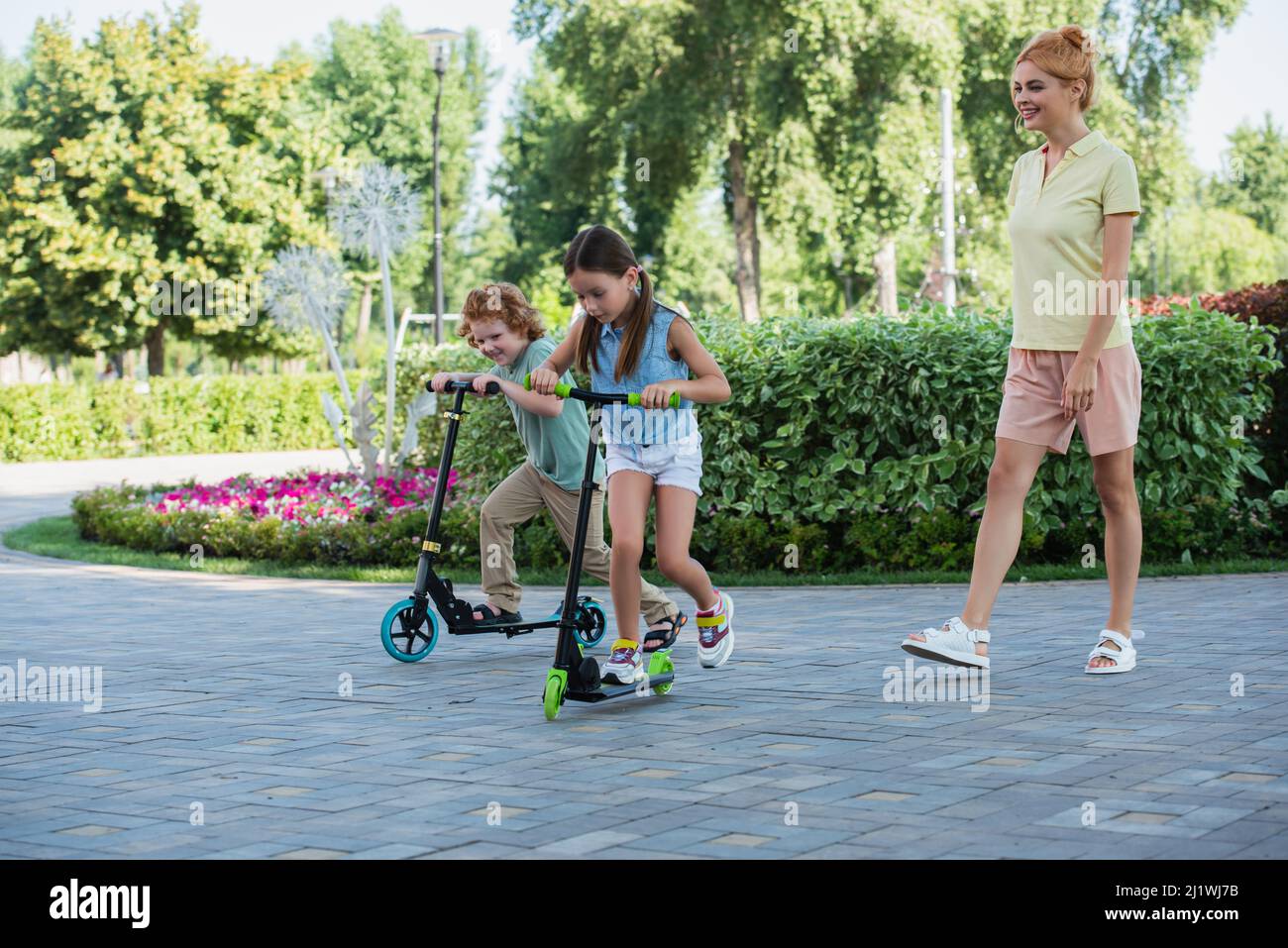 Kids riding scooters hi-res stock photography and images - Alamy