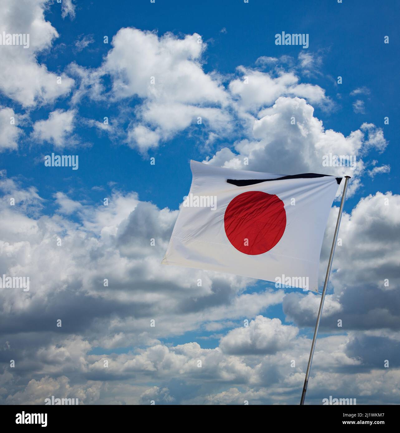 Japan flag waving against blue sky, close up. Japanese flag on pole ...