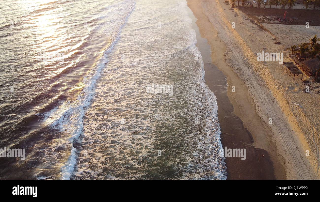 An top view of waves hitting a long shoreline during summertime Stock ...