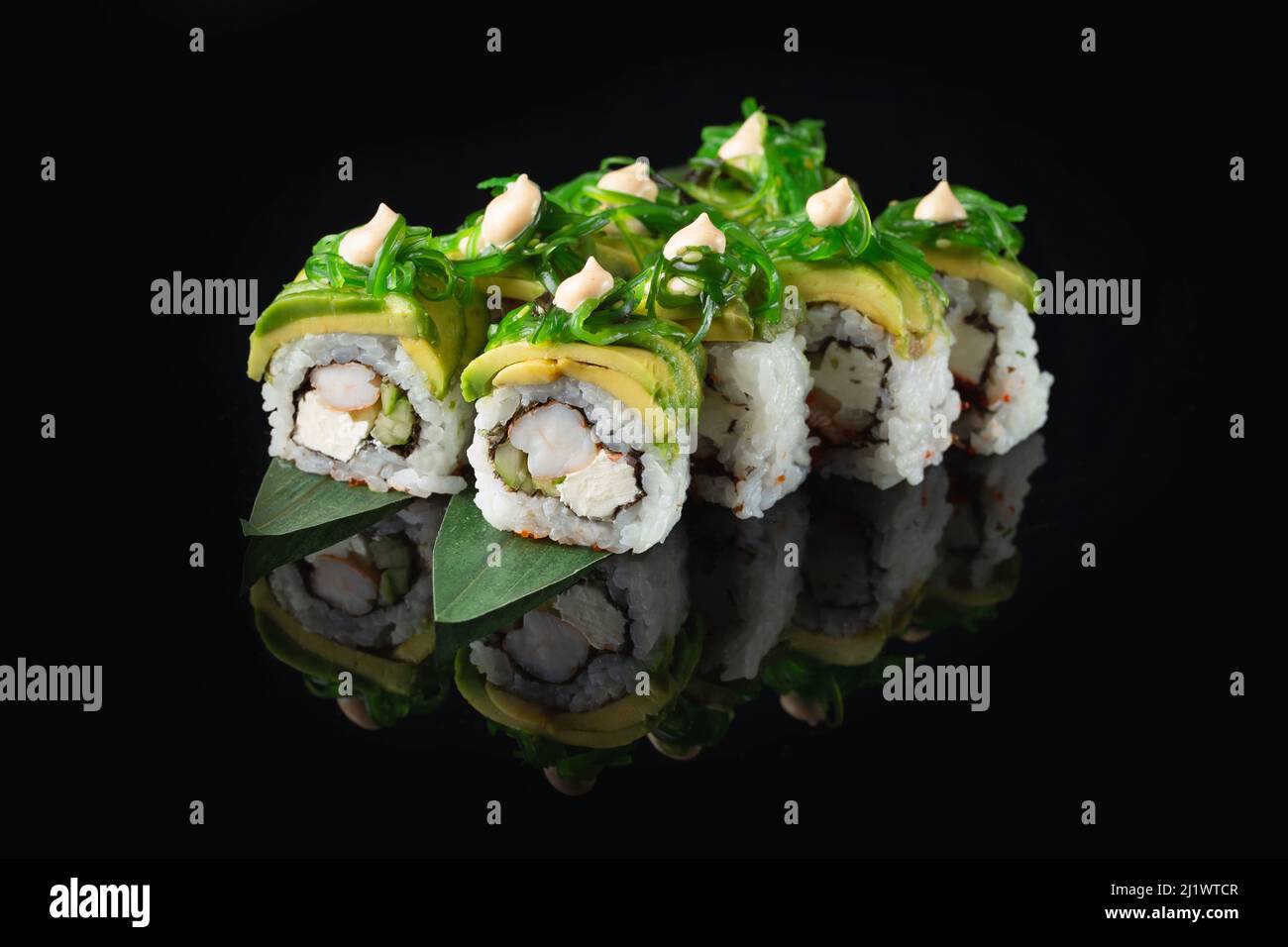 Traditional delicious fresh sushi roll set on a black background with ...