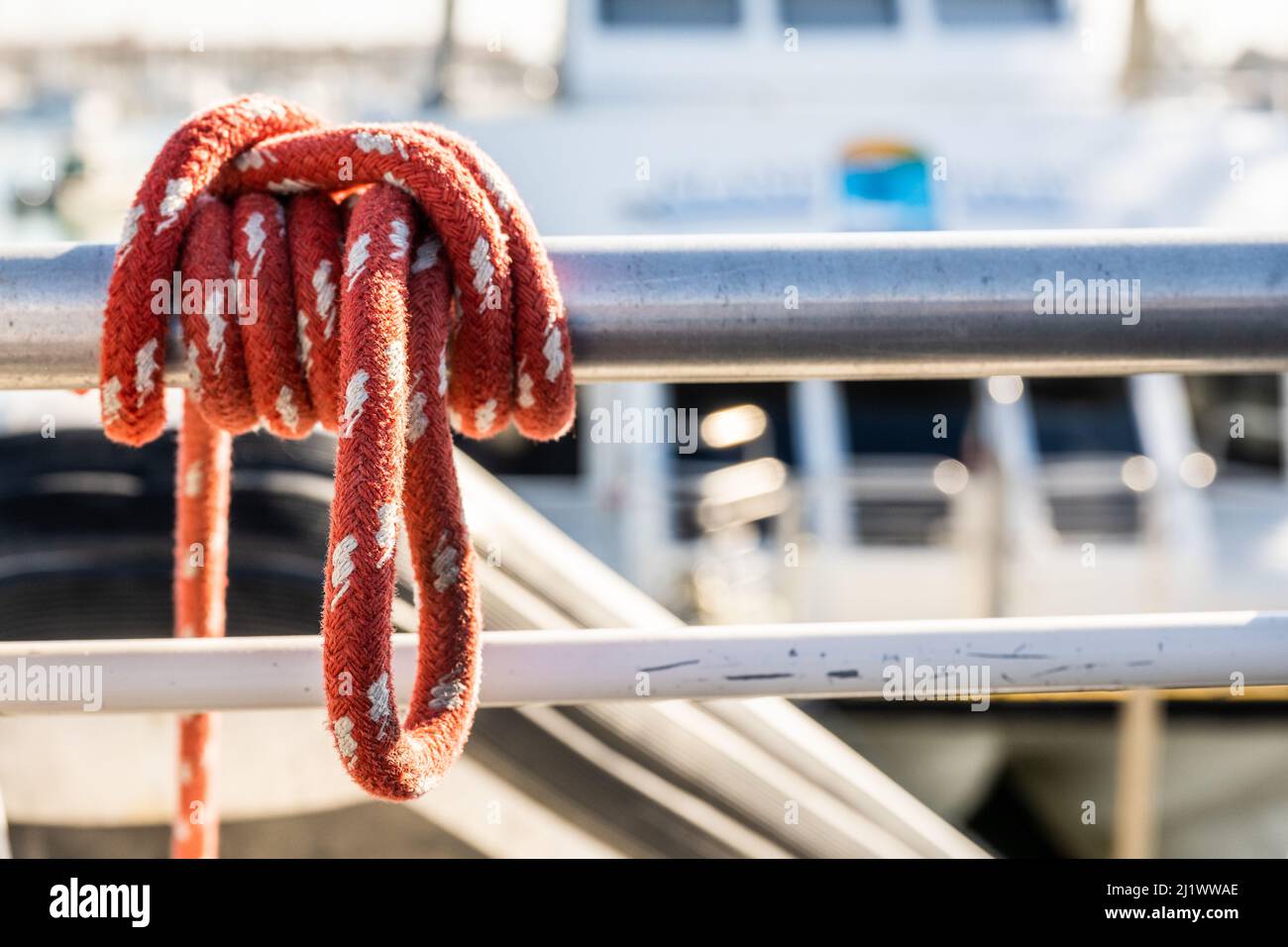 Red Rope Tied Around Metal Railing on boat with copy space Stock Photo ...
