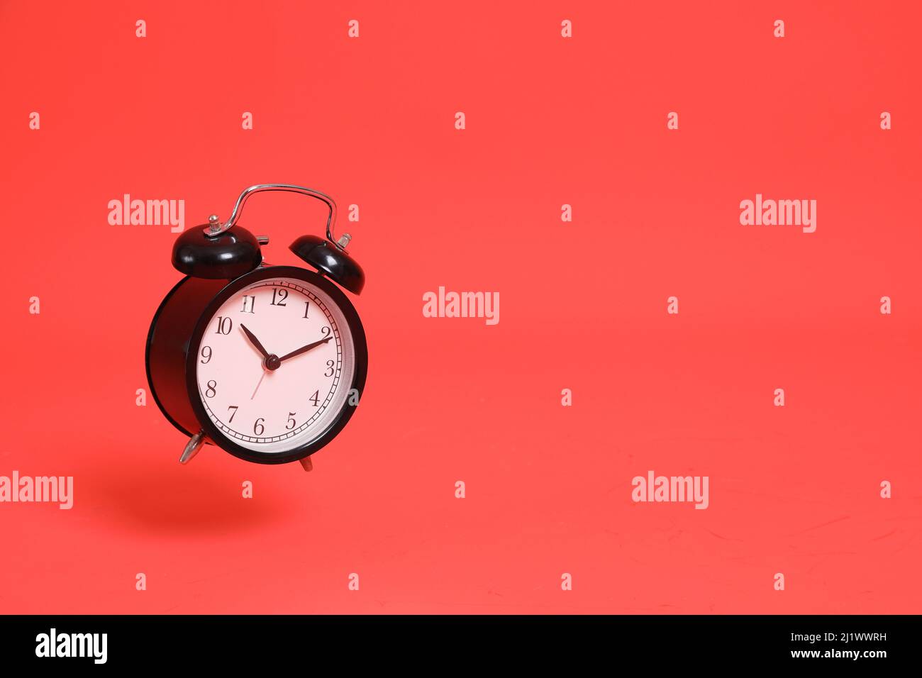 The isolated picture of clock floating on the orange background Stock ...