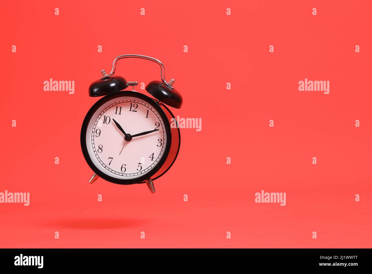 The isolated picture of clock floating on the orange background Stock ...