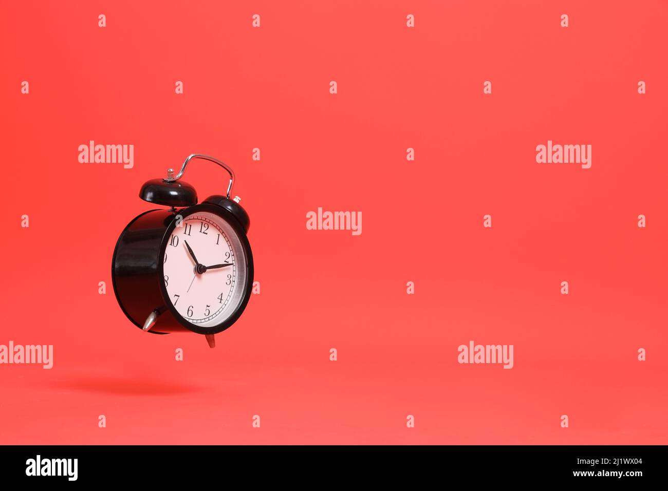 The isolated picture of clock floating on the orange background Stock ...