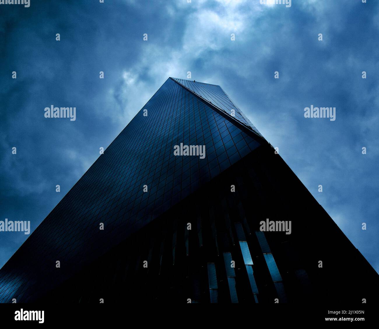 dark building rises into the blue sky Stock Photo - Alamy