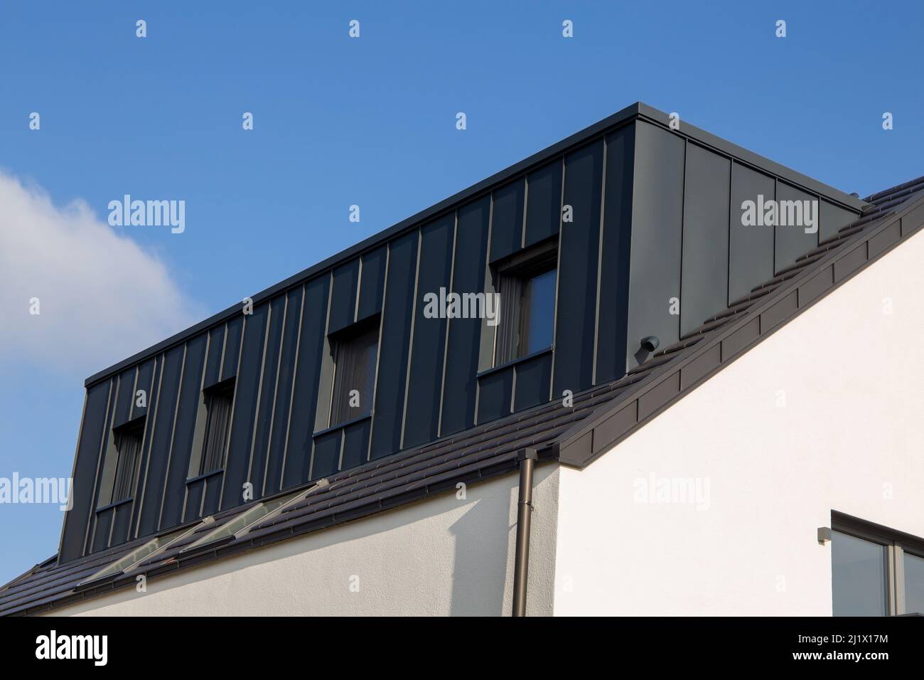 Newly tiled roof with large dormer with standing seam cladding Stock ...