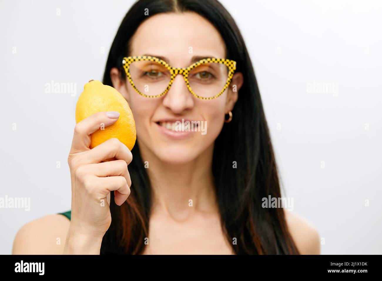 young woman hold lemon, raw fresh yellow citrus fruit, female happy ...