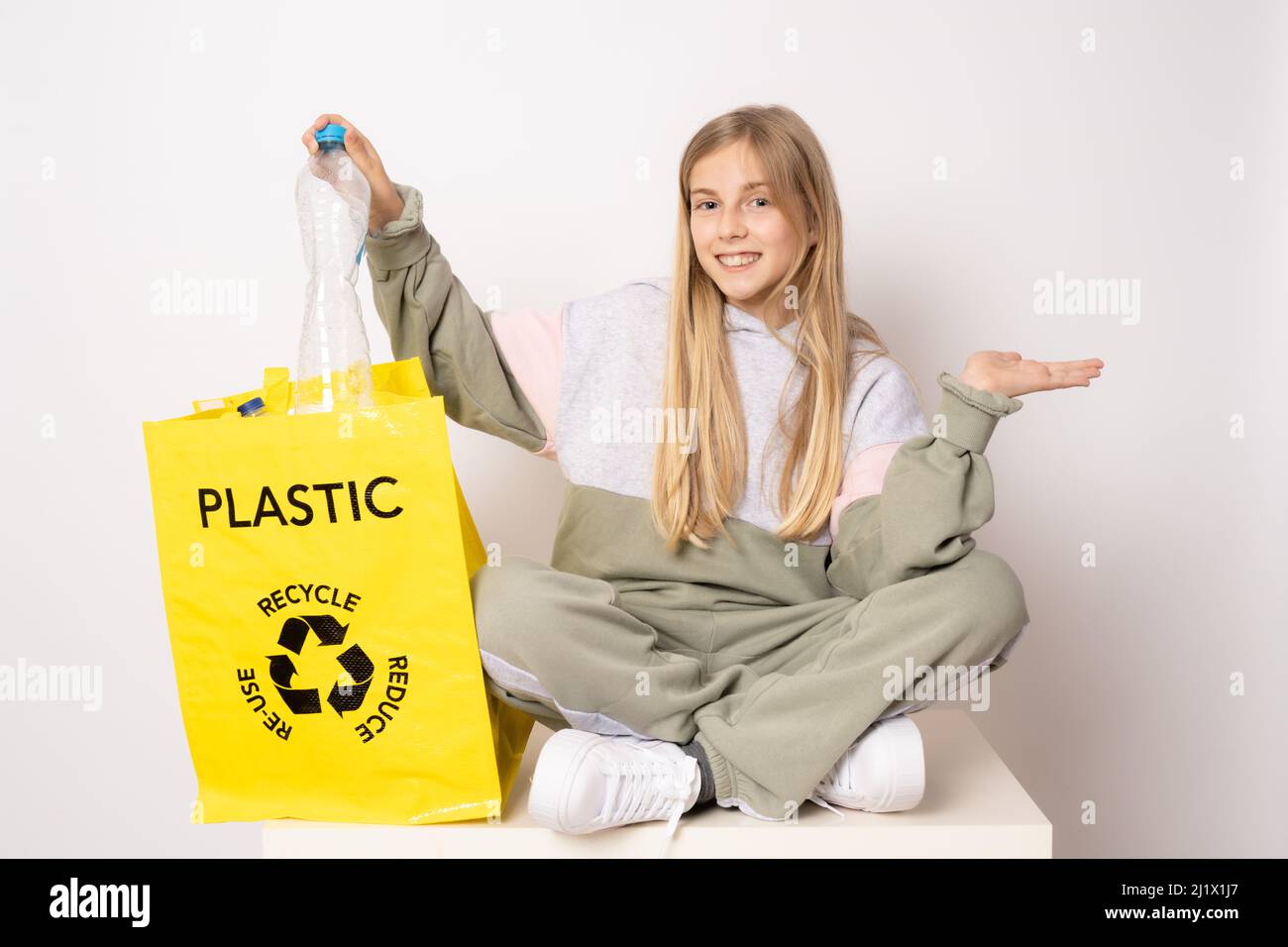 Smiling girl with an ecological bag isolated over a white background ...