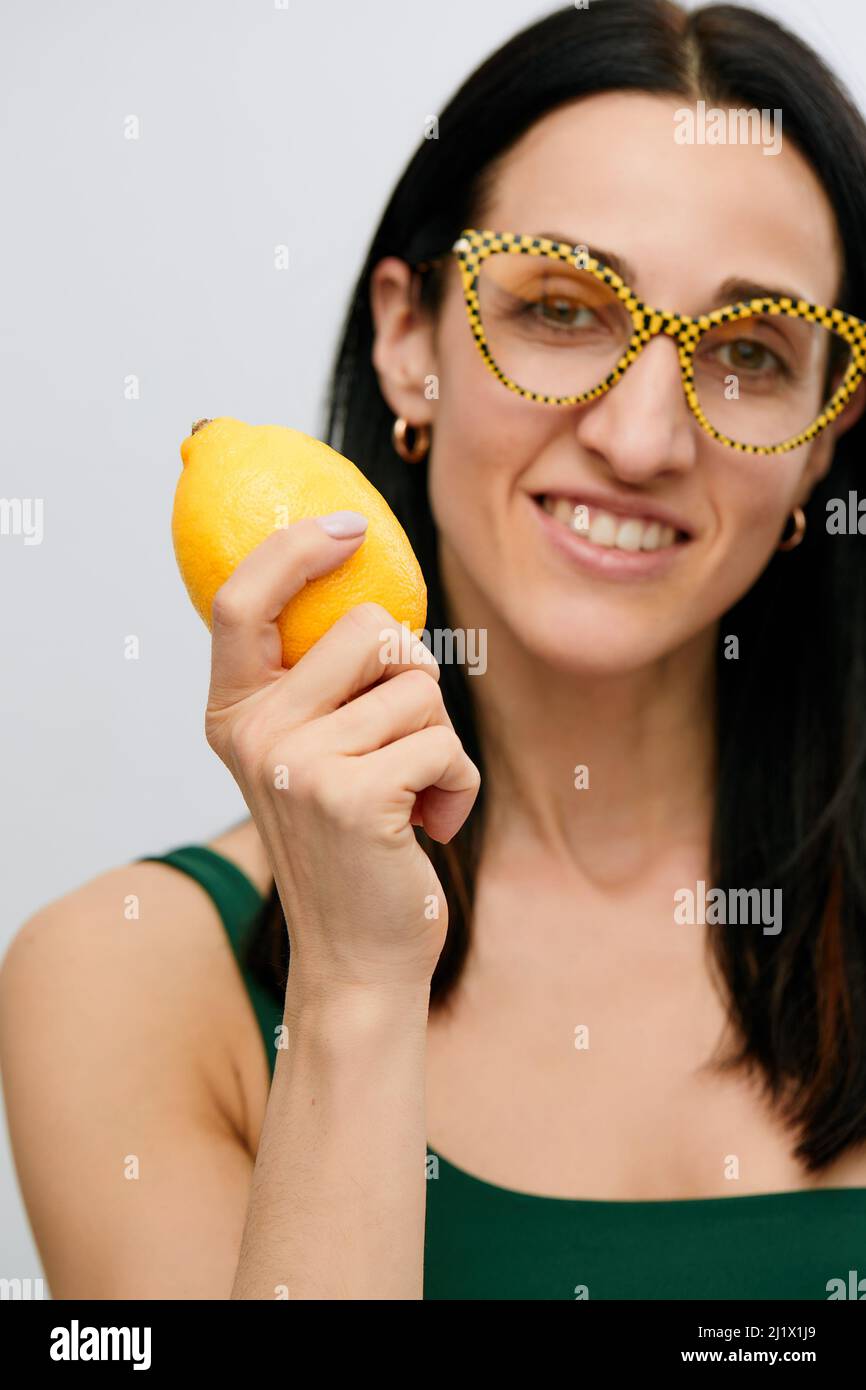 young woman hold lemon, raw fresh yellow citrus fruit, female happy ...