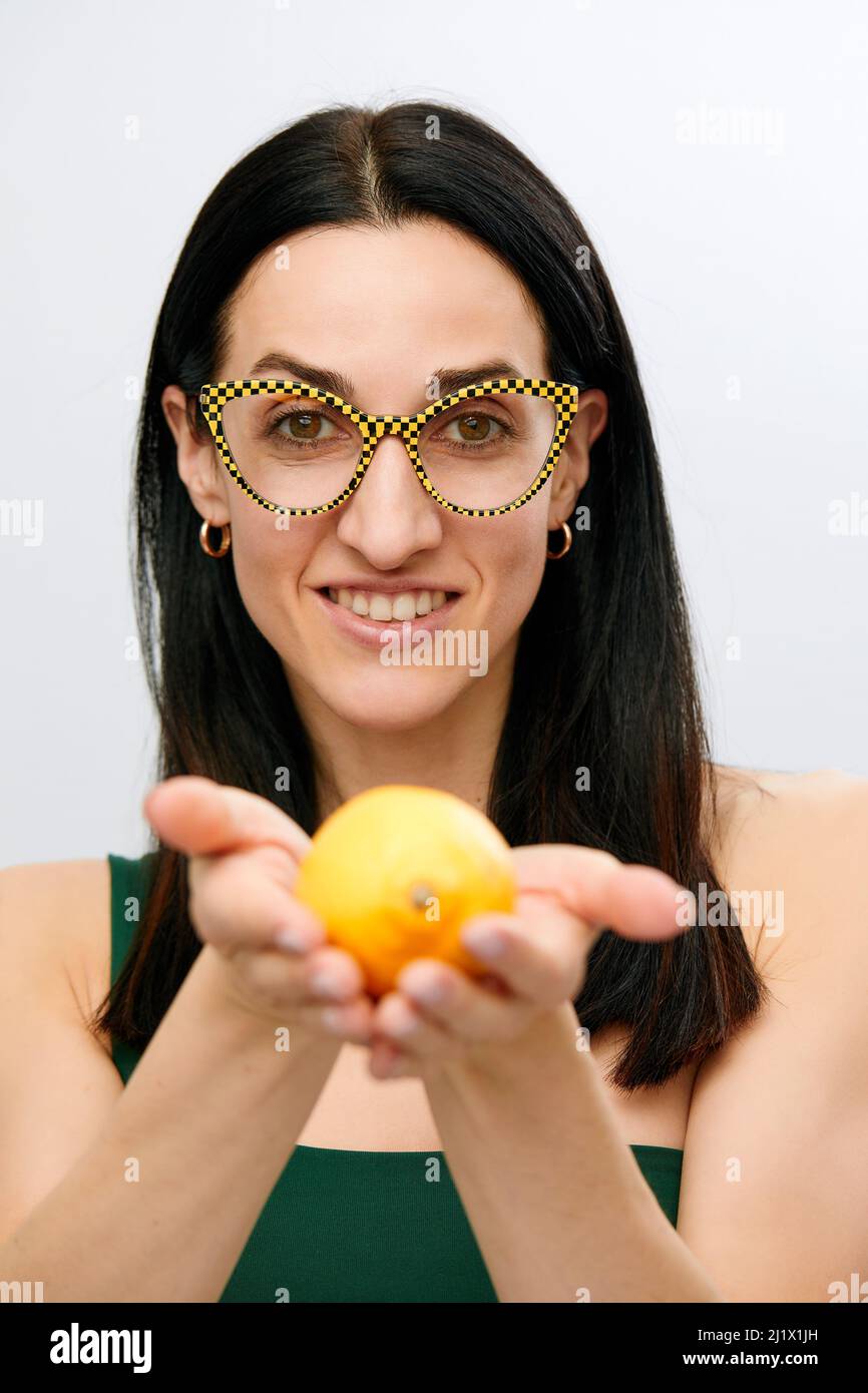 young woman hold lemon, raw fresh yellow citrus fruit, female happy ...