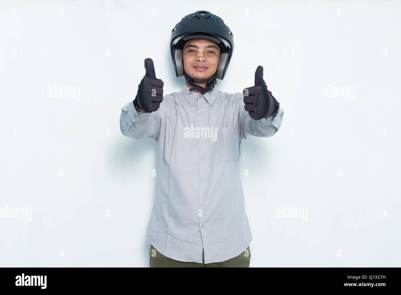 handsome asian man with a motorcycle helmet showing a thumbs up ok ...