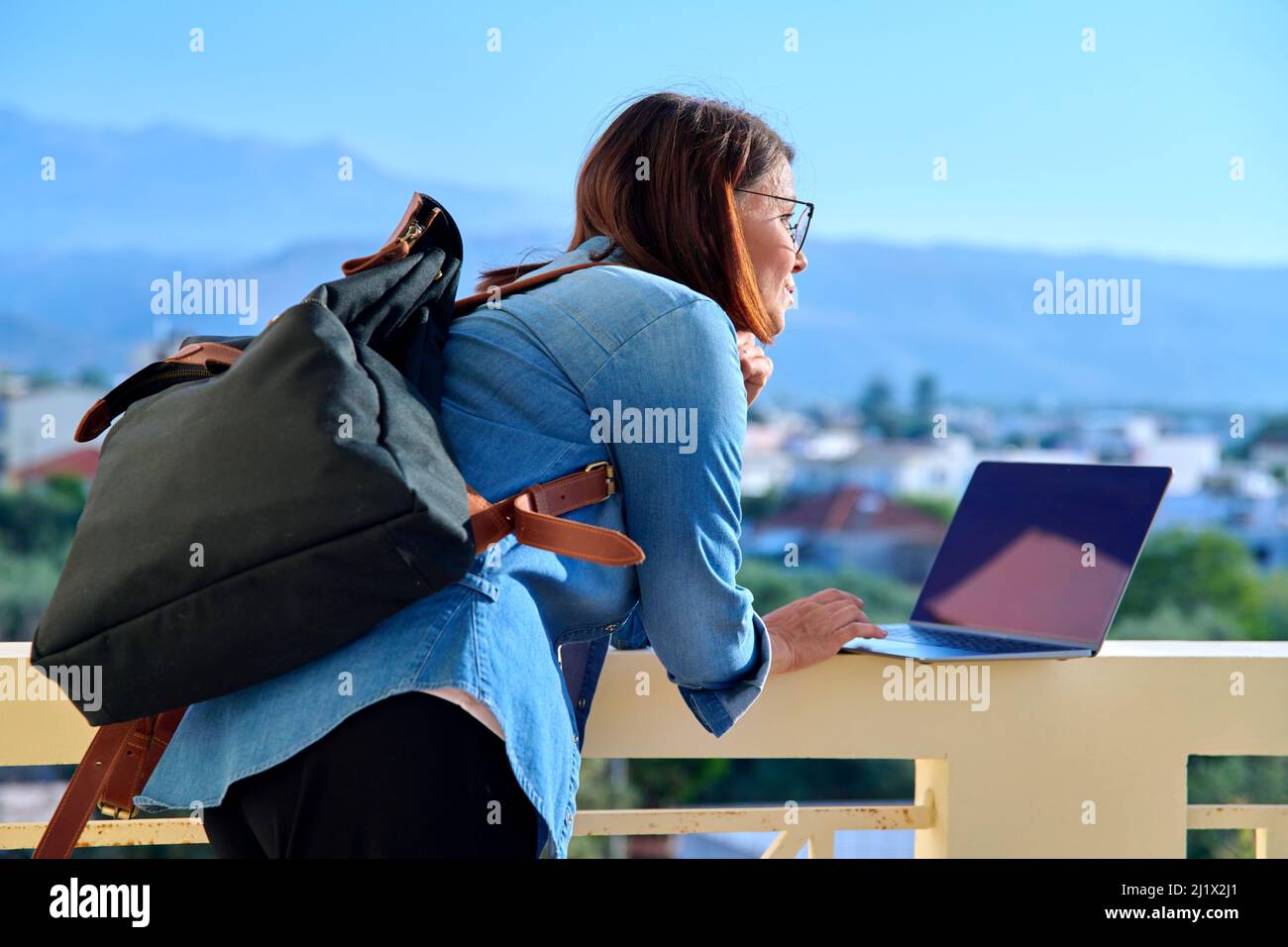 Confident serious mature business woman with laptop outdoors Stock ...