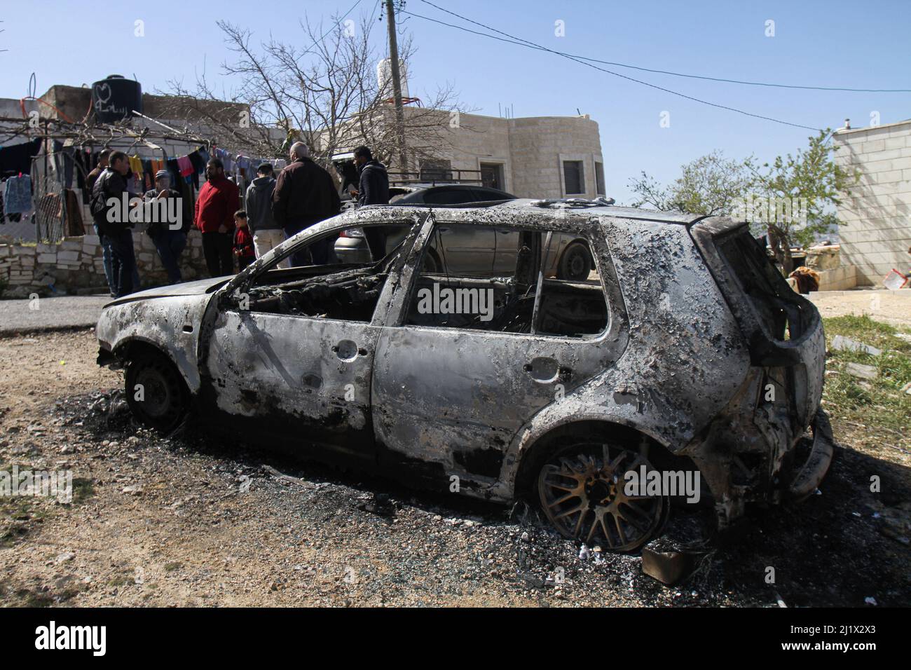 General view of a burnt car after the Israeli settlers set fire to four ...