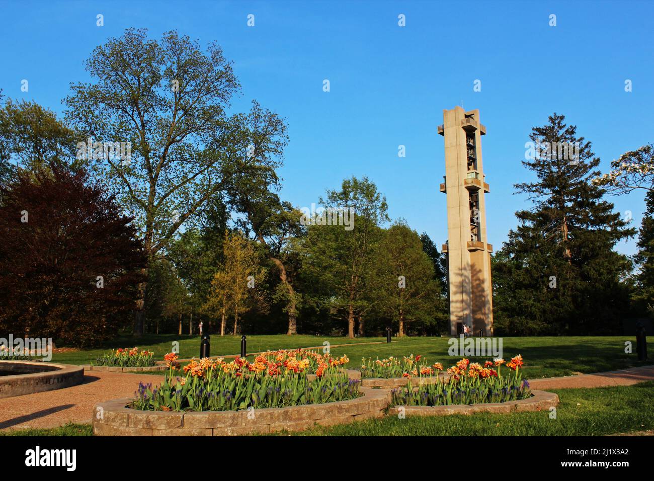 Concrete brutalist musical carillon bell tower in day light with flower ...