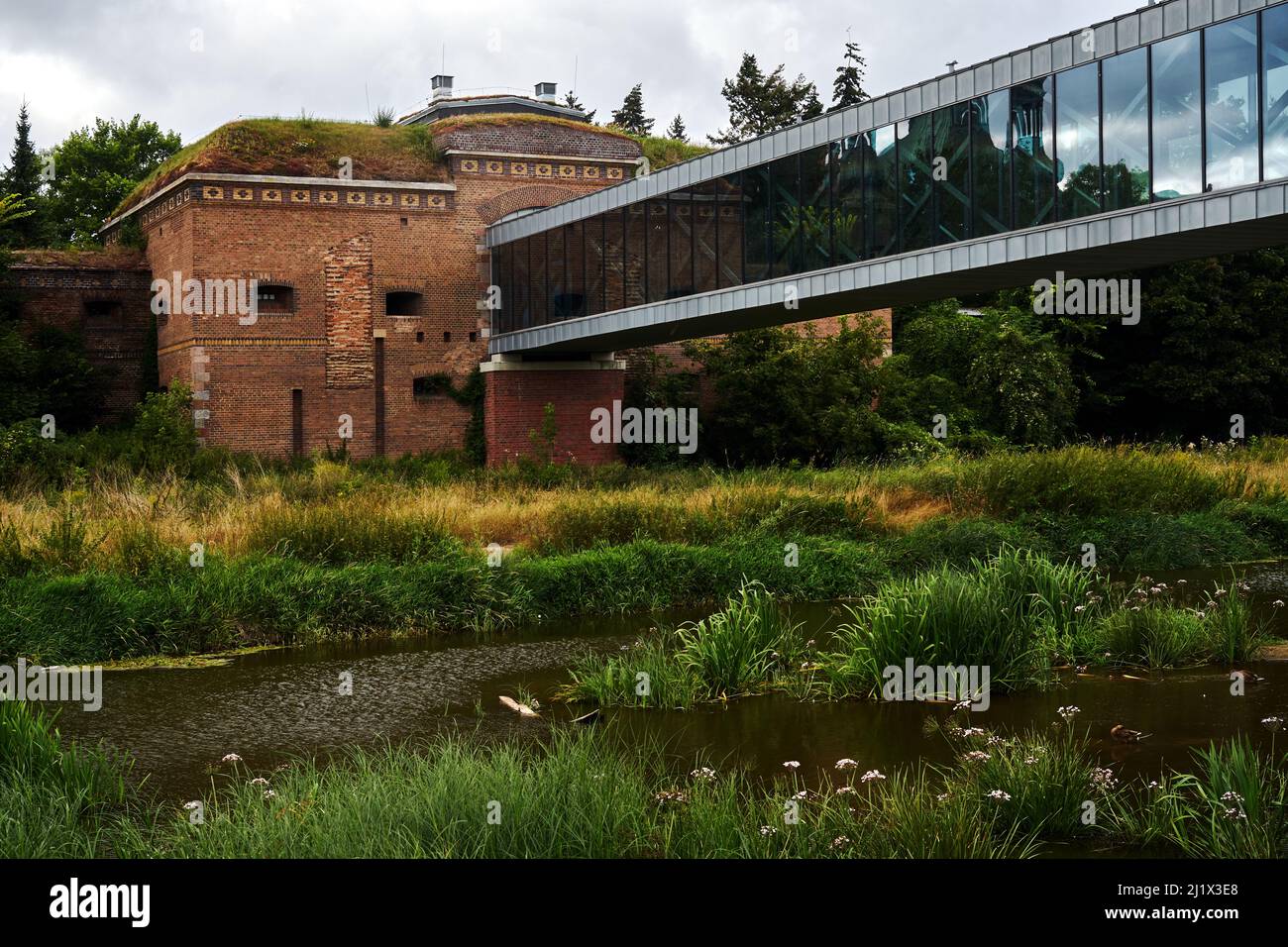 A fragment of a historic Prussian fortress and a modern footbridge over ...