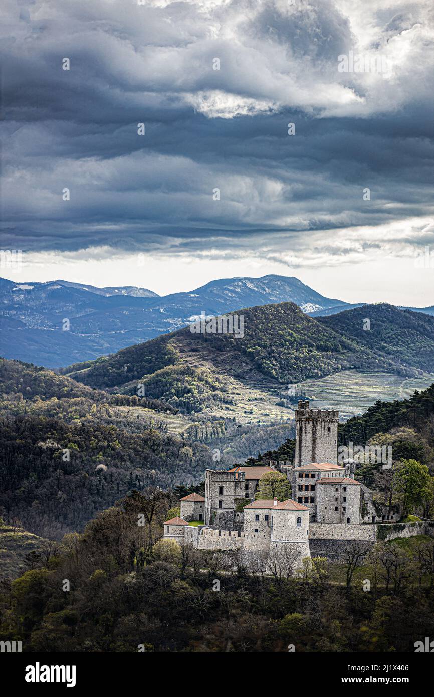 An vertical shot of the Rihemberk castle surrounded by mountains on a ...