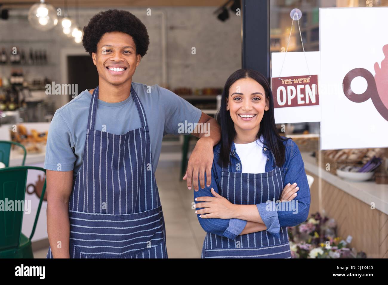Portrait of confident young male and female multiracial baristas ...