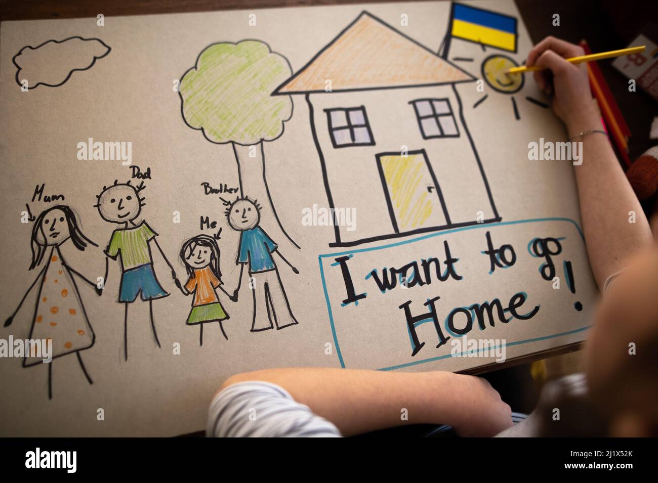 Top view of Ukrainian refugee schoolgirl missing home and drawing her ...