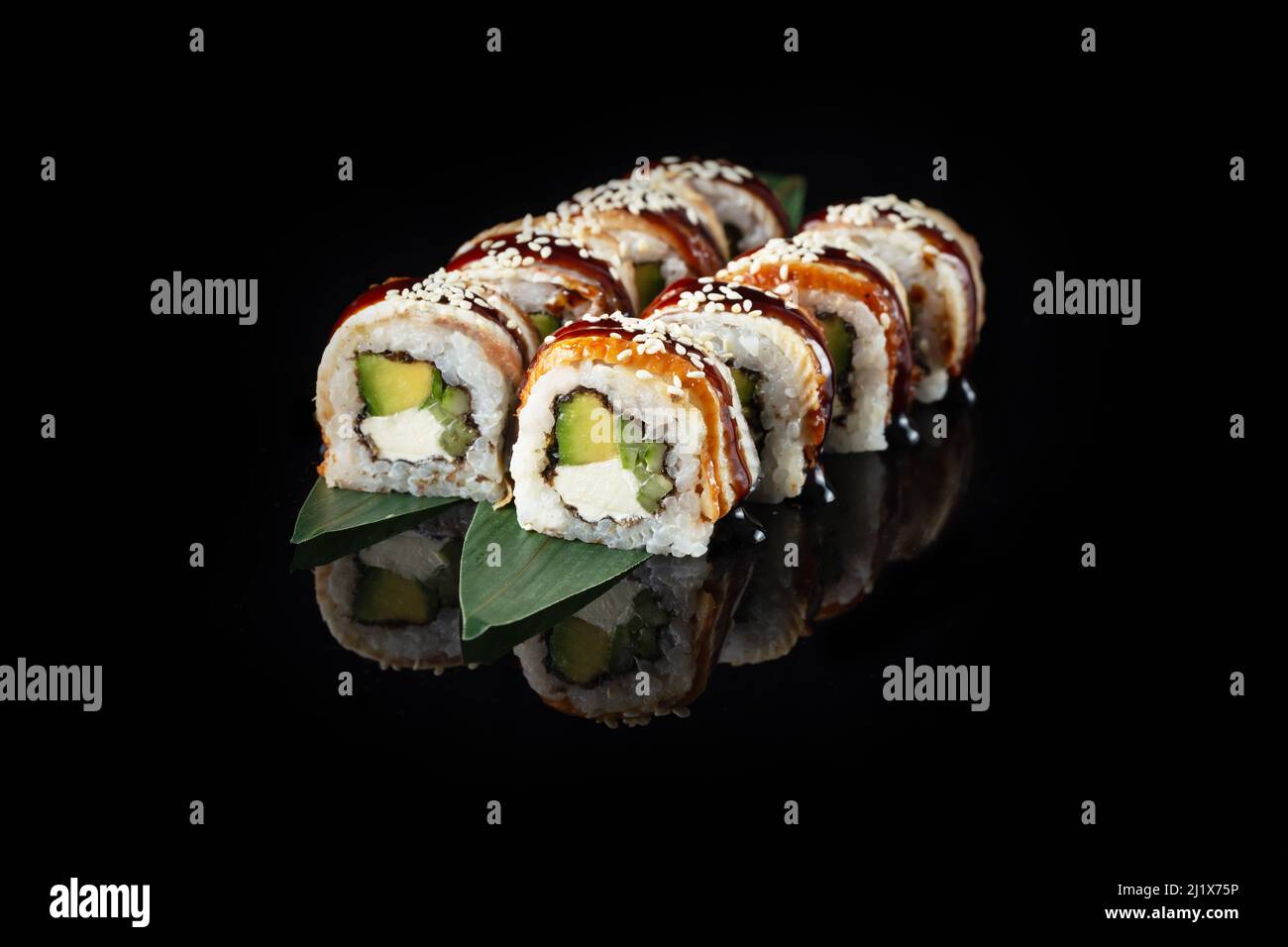 Traditional delicious fresh sushi roll set on a black background with ...