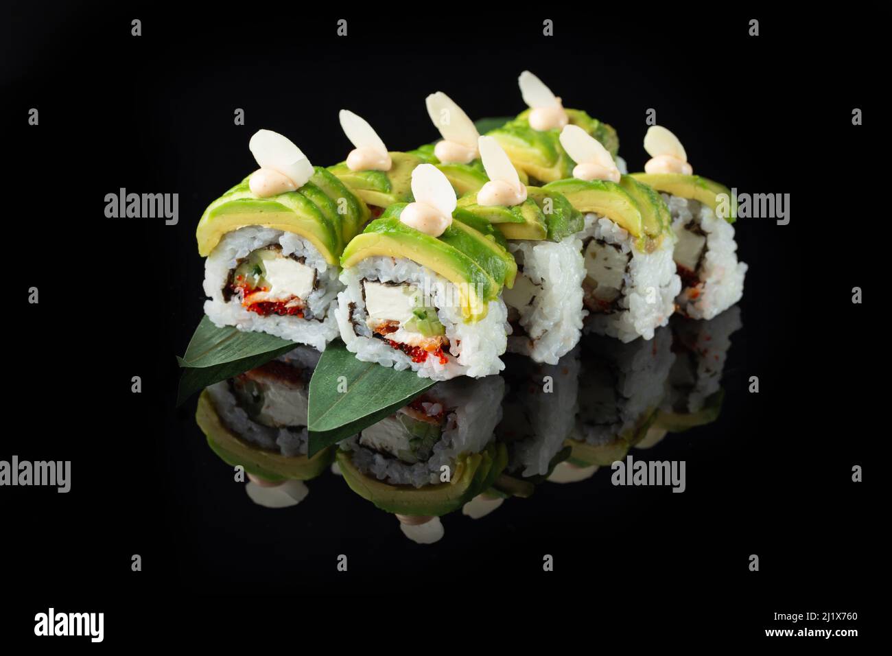 Traditional delicious fresh sushi roll set on a black background with ...