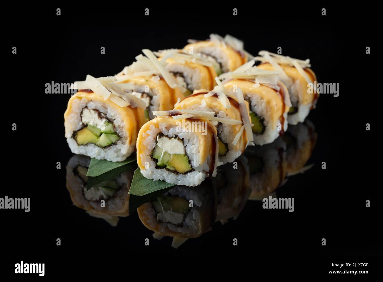 Traditional delicious fresh sushi roll set on a black background with ...