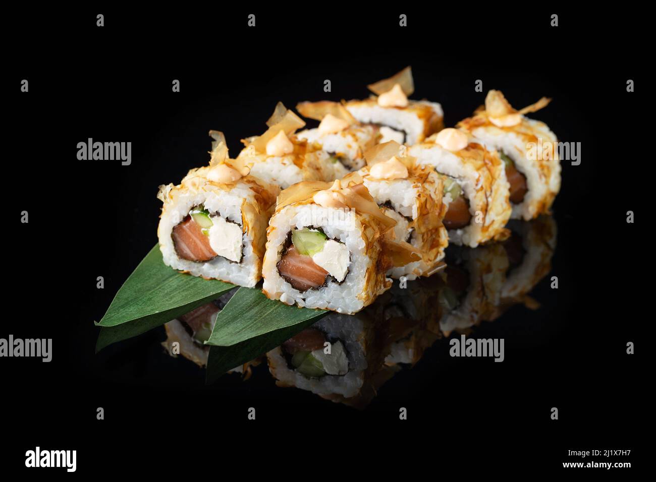 Traditional delicious fresh sushi roll set on a black background with ...
