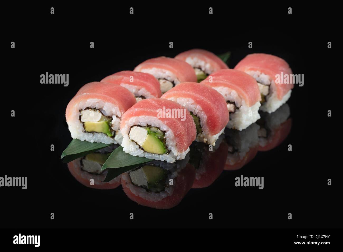 Traditional delicious fresh sushi roll set on a black background with ...