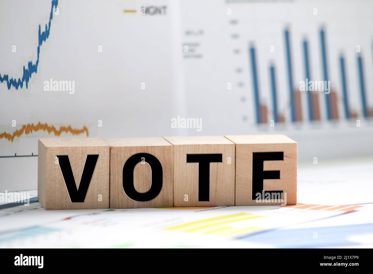 Vote, word in 3d wooden alphabet letters isolated on red background ...