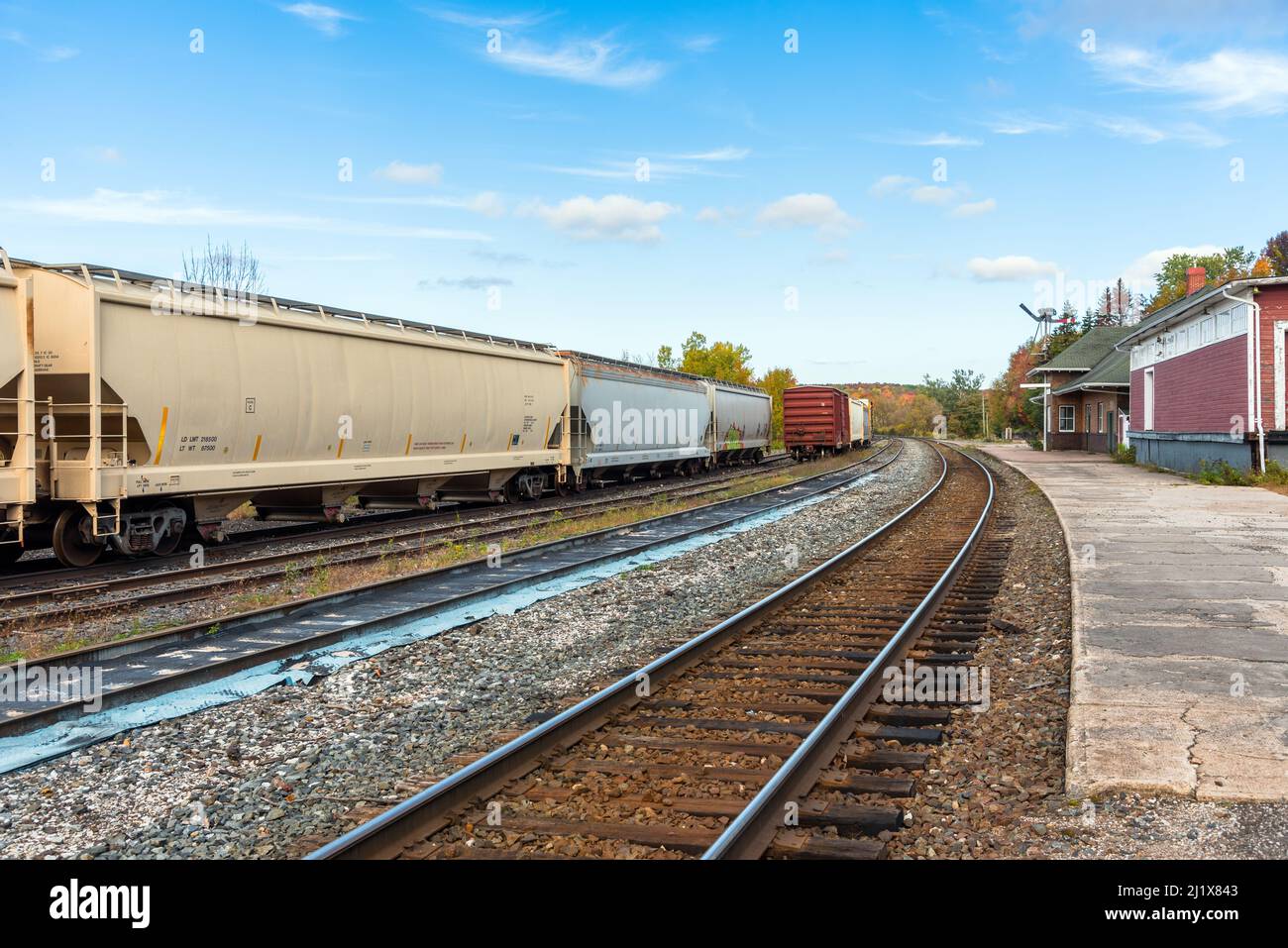 Wagons in a small train station on a clear autumn day Stock Photo - Alamy