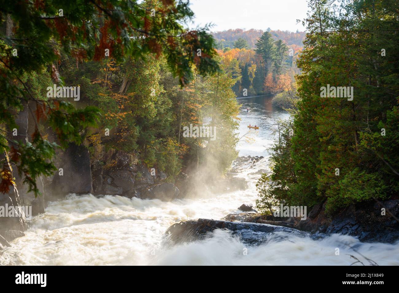 View form above of a majestic waterfall on a sunny autumn day. People ...