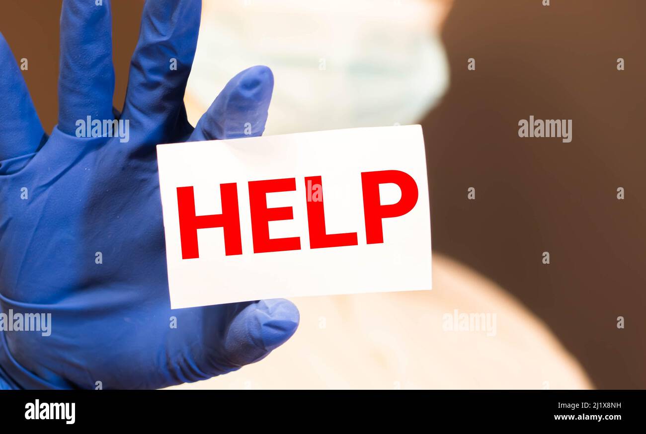 We can help text on card and hand holding it. Healthcare or prevention ...