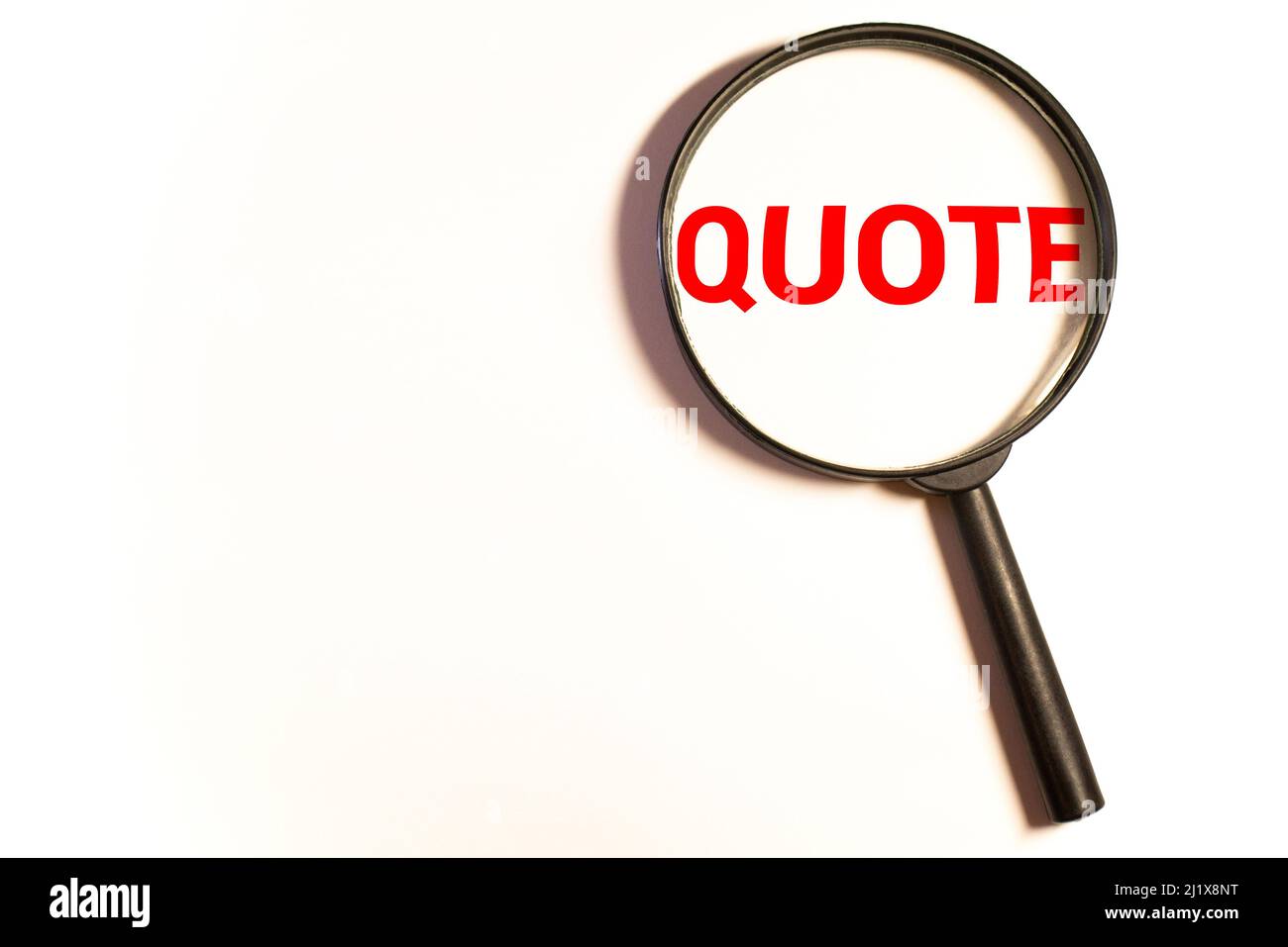 Magnifying glass on papers with word quote of quote written on it Stock ...