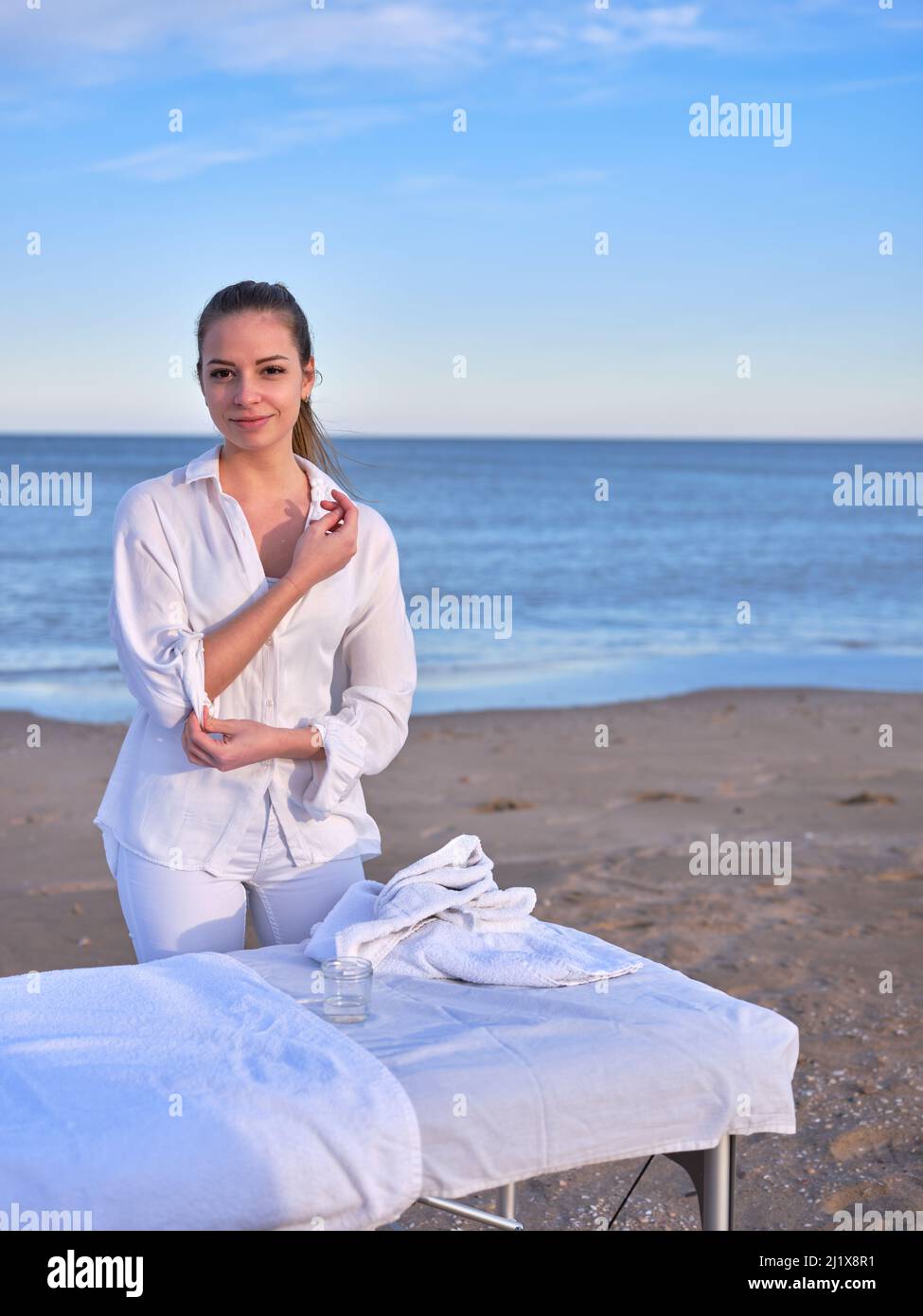 A young chiromassage therapist posing and standing near of the massage ...