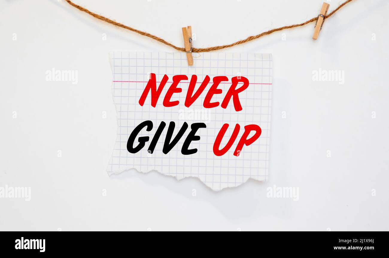Never Give Up message note, business concept Stock Photo - Alamy