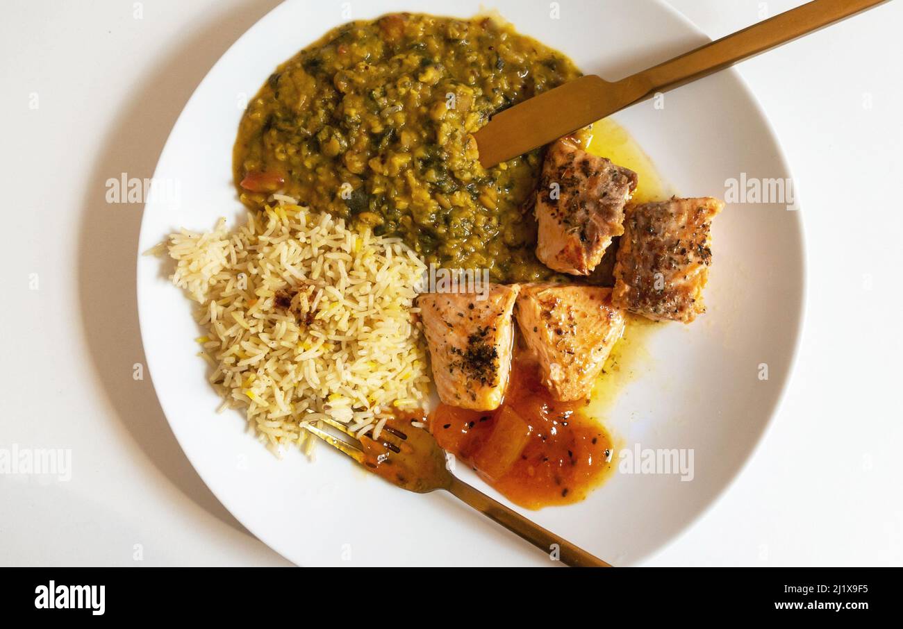 Salmon sauteed in lemon butter with rice, dahl, and mango chutney Stock ...