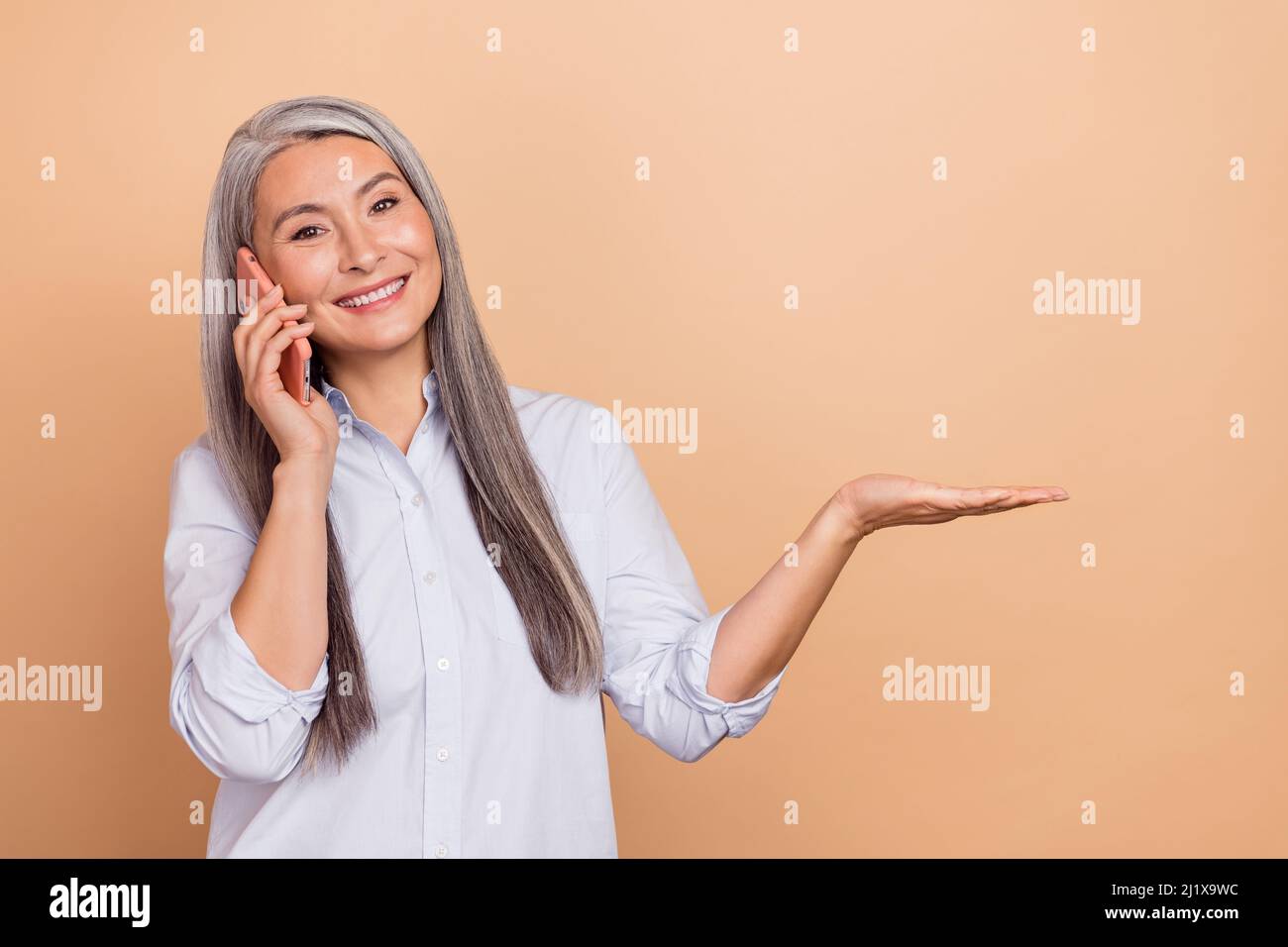 Photo of aged lady listen tell mobile promoter proposition sale select ...