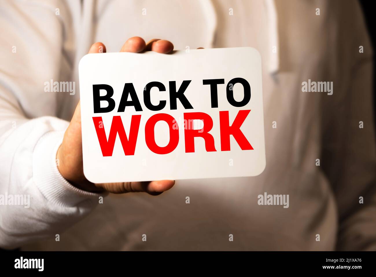 Hand writing 'back to work', isolated on beautiful white background ...