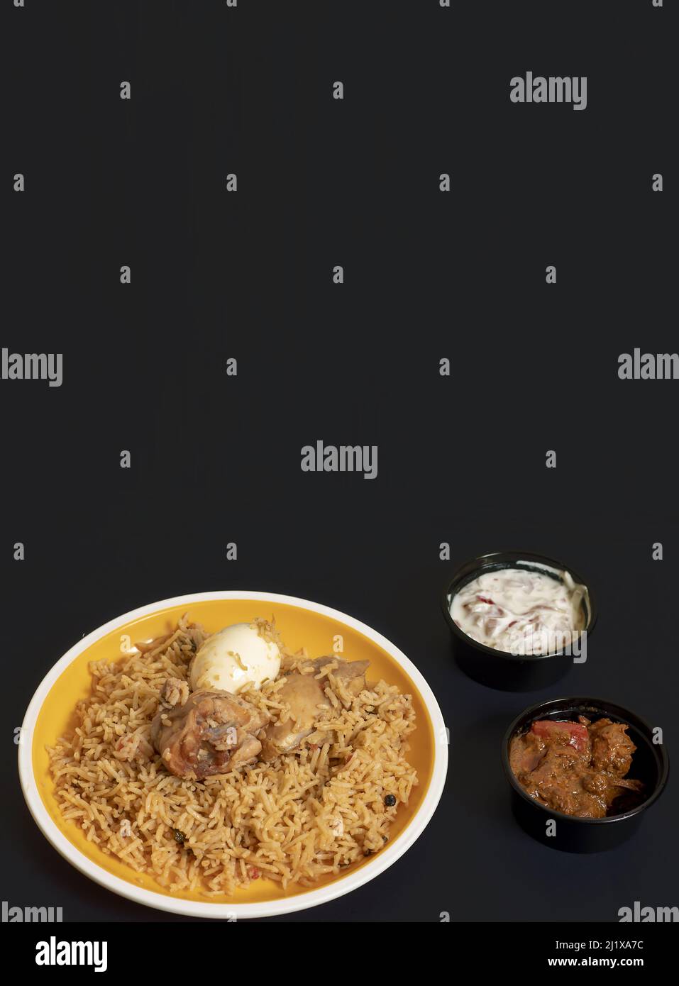 A vertical shot of Indian Idli food on an orange plate isolated on a ...