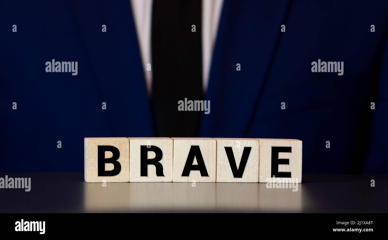 BRAVE word written on wood block. business concept Stock Photo - Alamy