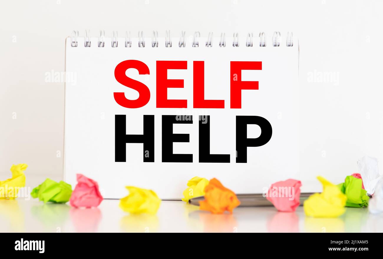 Black book with the words self-help title on front. Isolated on white ...