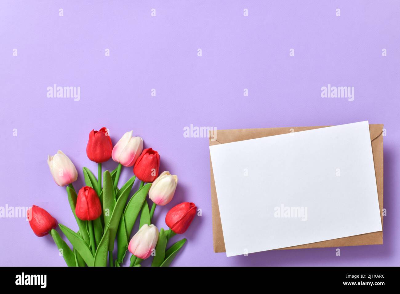 A festive banner with tulips and an envelope on a purple background ...