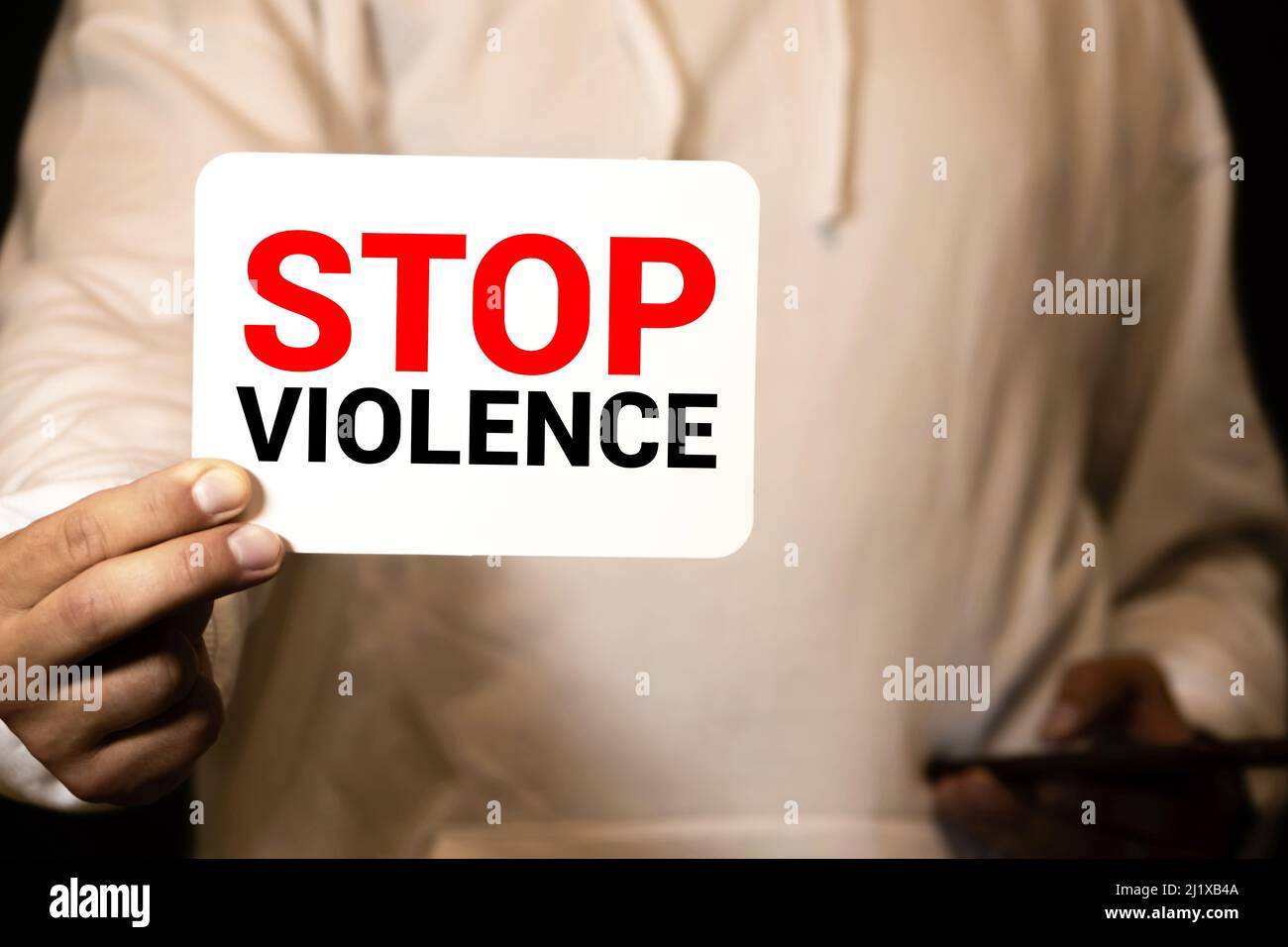 Stop violence stamped on white paper. Red ink drops from fountain pen ...