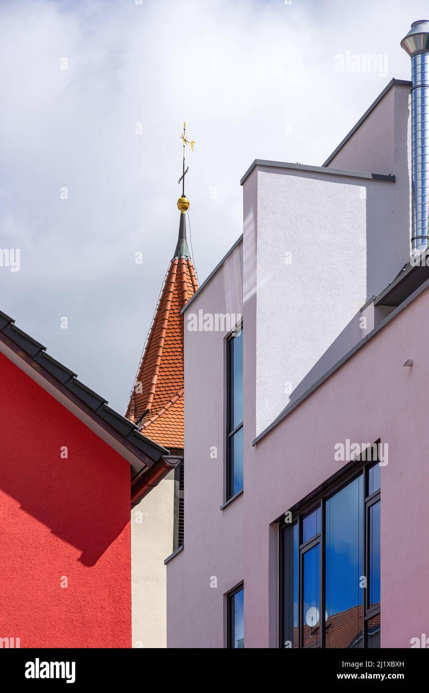 Historical church steeple in contrast to modern architecture in Ebingen ...