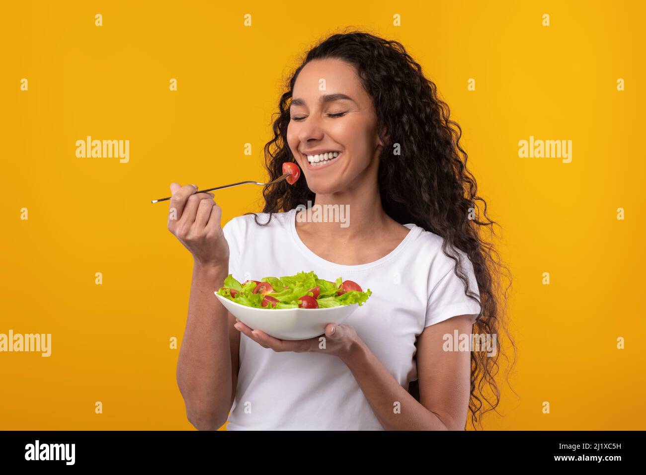 Woman holding fork and smiling at hi-res stock photography and images ...